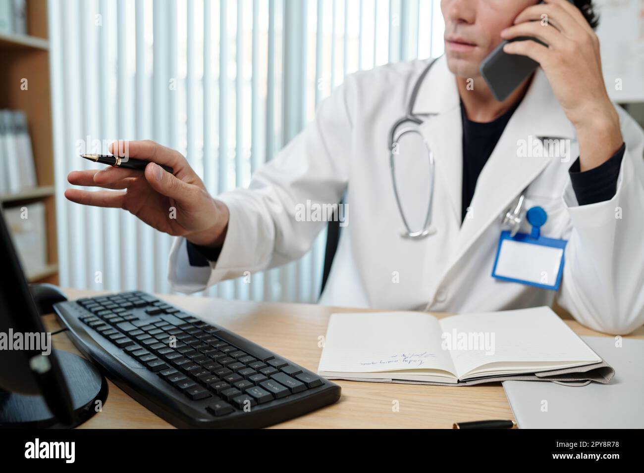 Physician analyzing results of medical tests on computer screen when ...