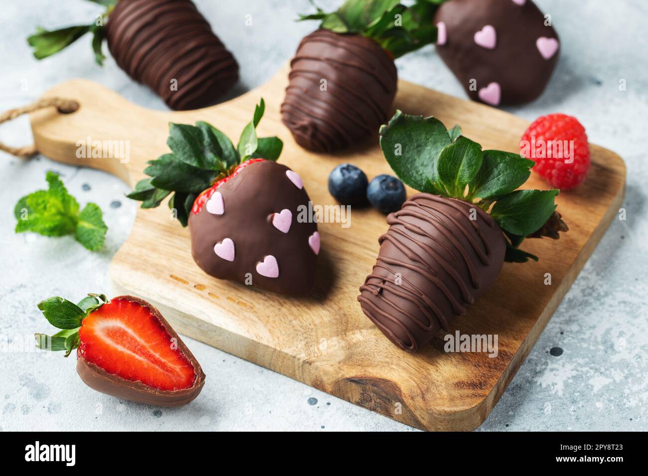 Gourmet chocolate covered strawberries on the light background Stock ...