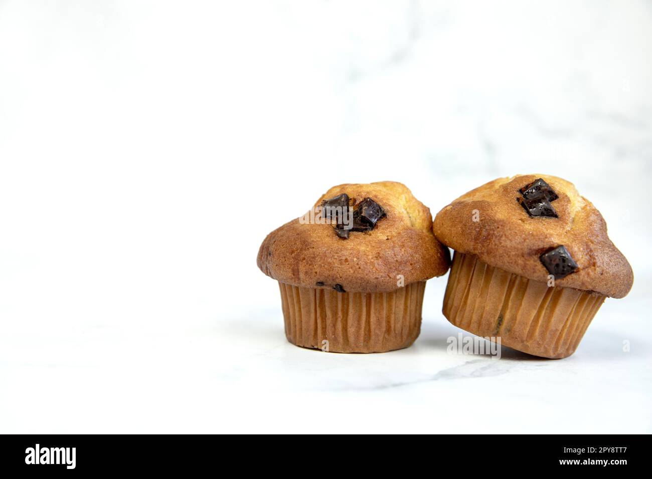 A stack of delicious chocolatechip banana muffins and blueberries on a ...