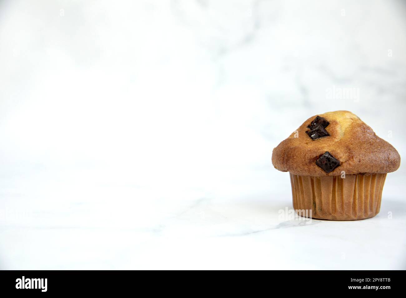 A stack of delicious chocolatechip banana muffins and blueberries on a ...