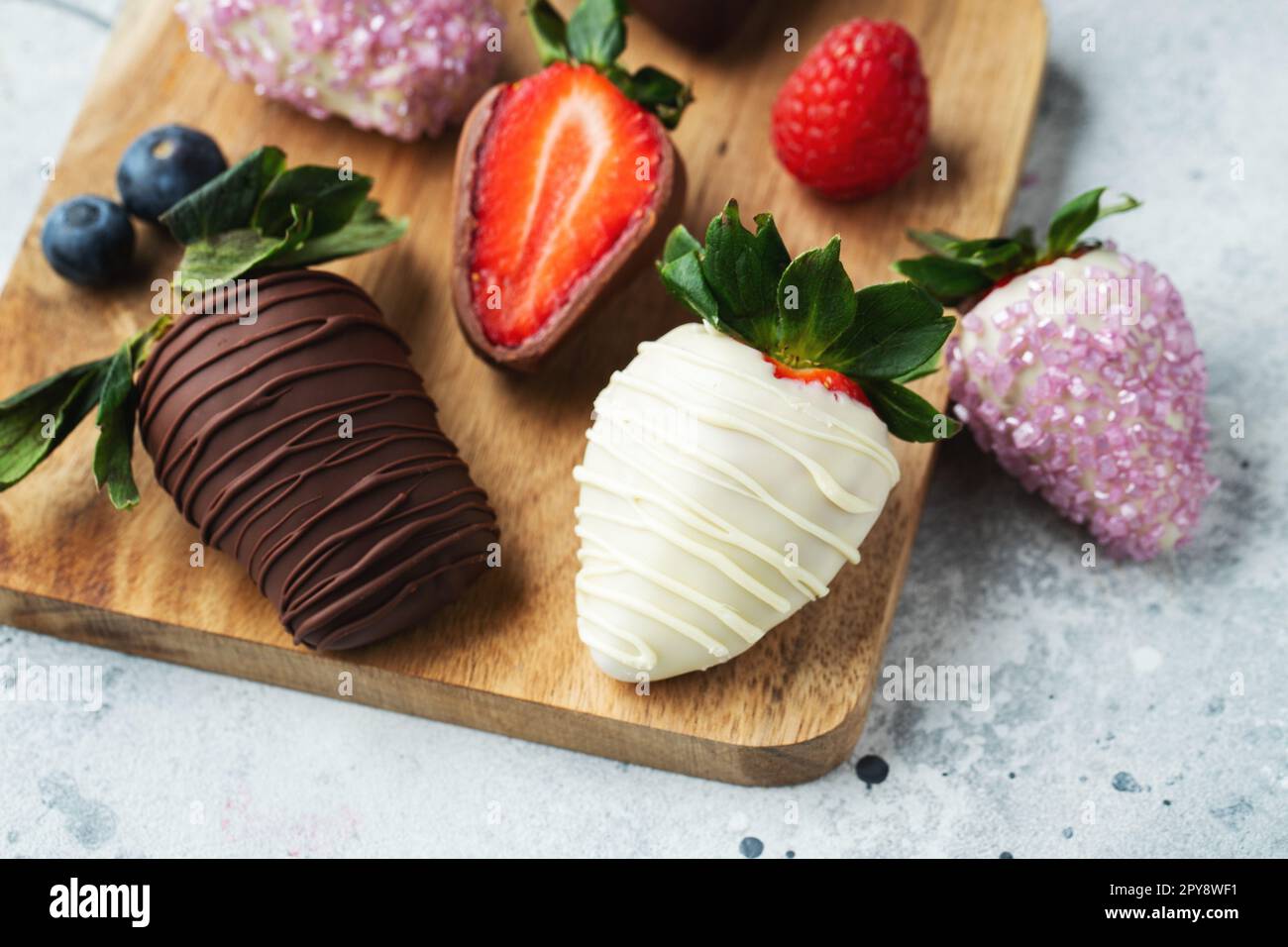 Gourmet chocolate covered strawberries on the light background Stock ...