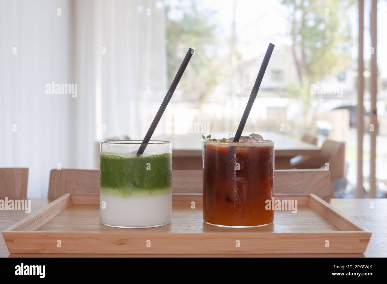 Iced americano with orange and iced matcha green tea in coffee shop ...