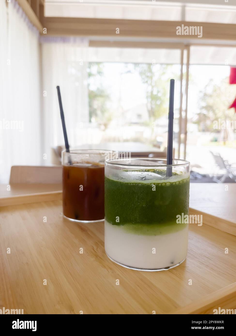 Iced americano with orange and iced matcha green tea in coffee shop ...