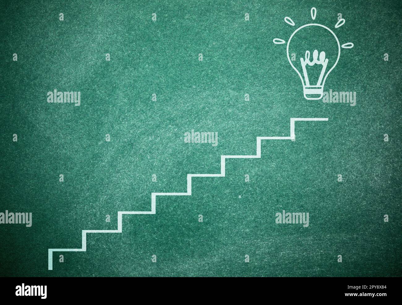 Stairs with light bulb drawn on green chalkboard. Steps to success ...