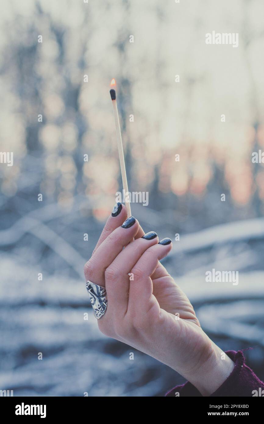 Close up female hand holding burning match concept photo Stock Photo ...