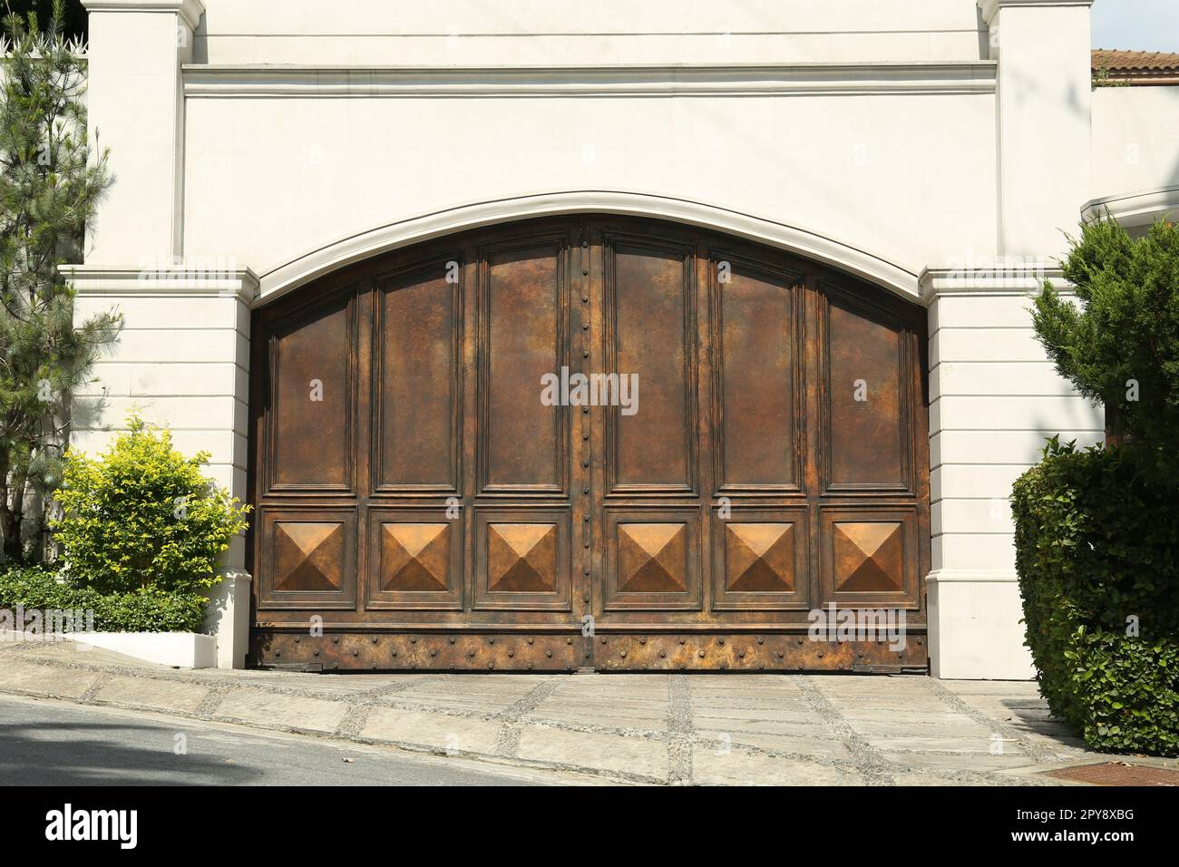 Beautiful old metal gate and white wall outdoors Stock Photo - Alamy