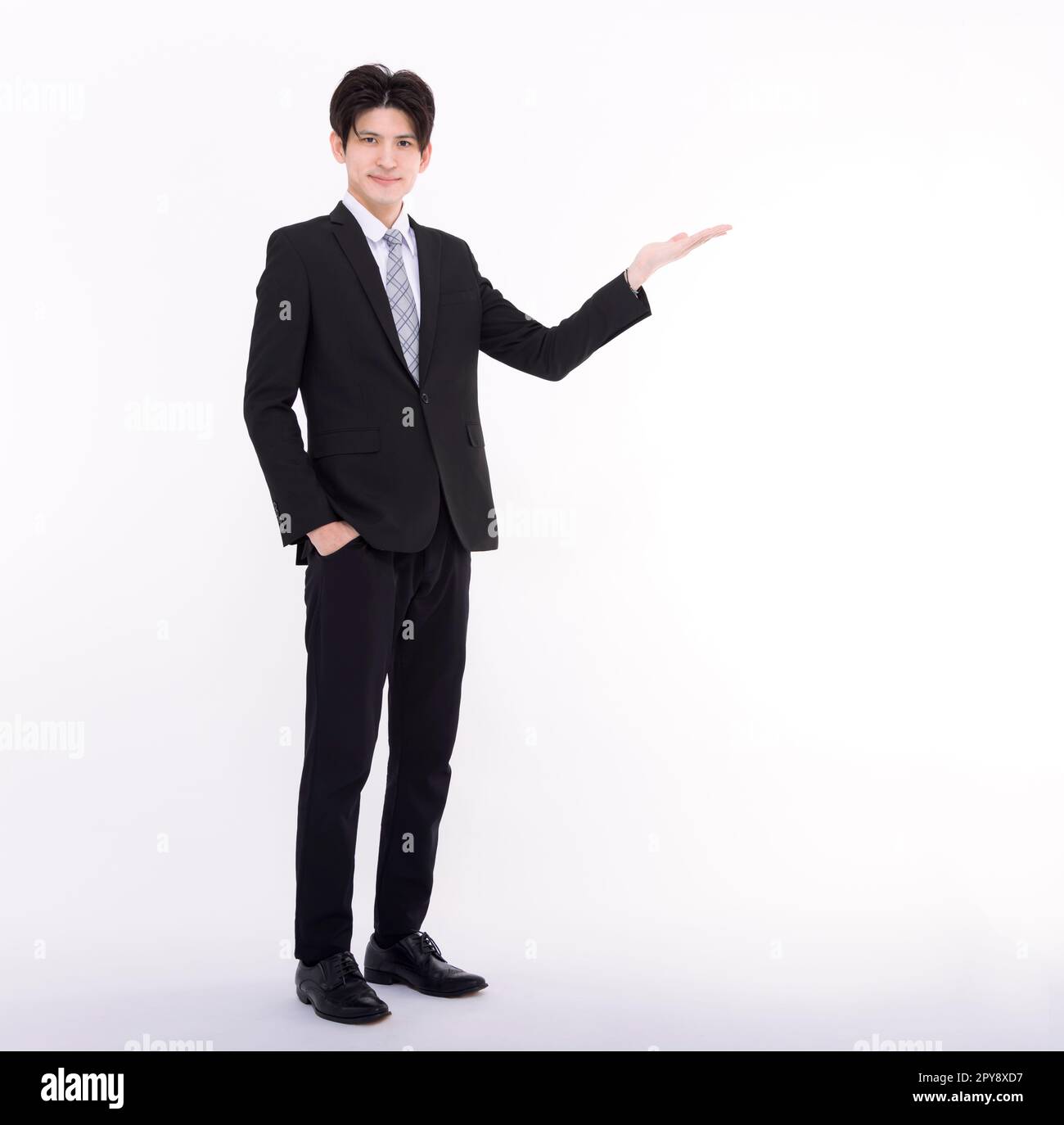 Asian young business man present something isolated on white background ...