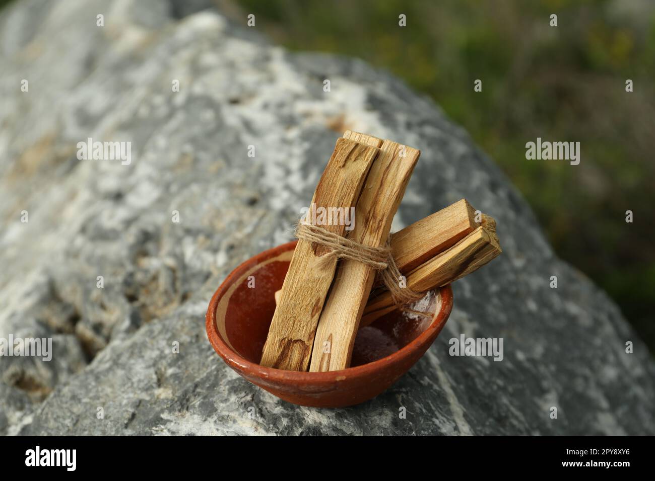 Many palo santo sticks on stone surface outdoors Stock Photo - Alamy