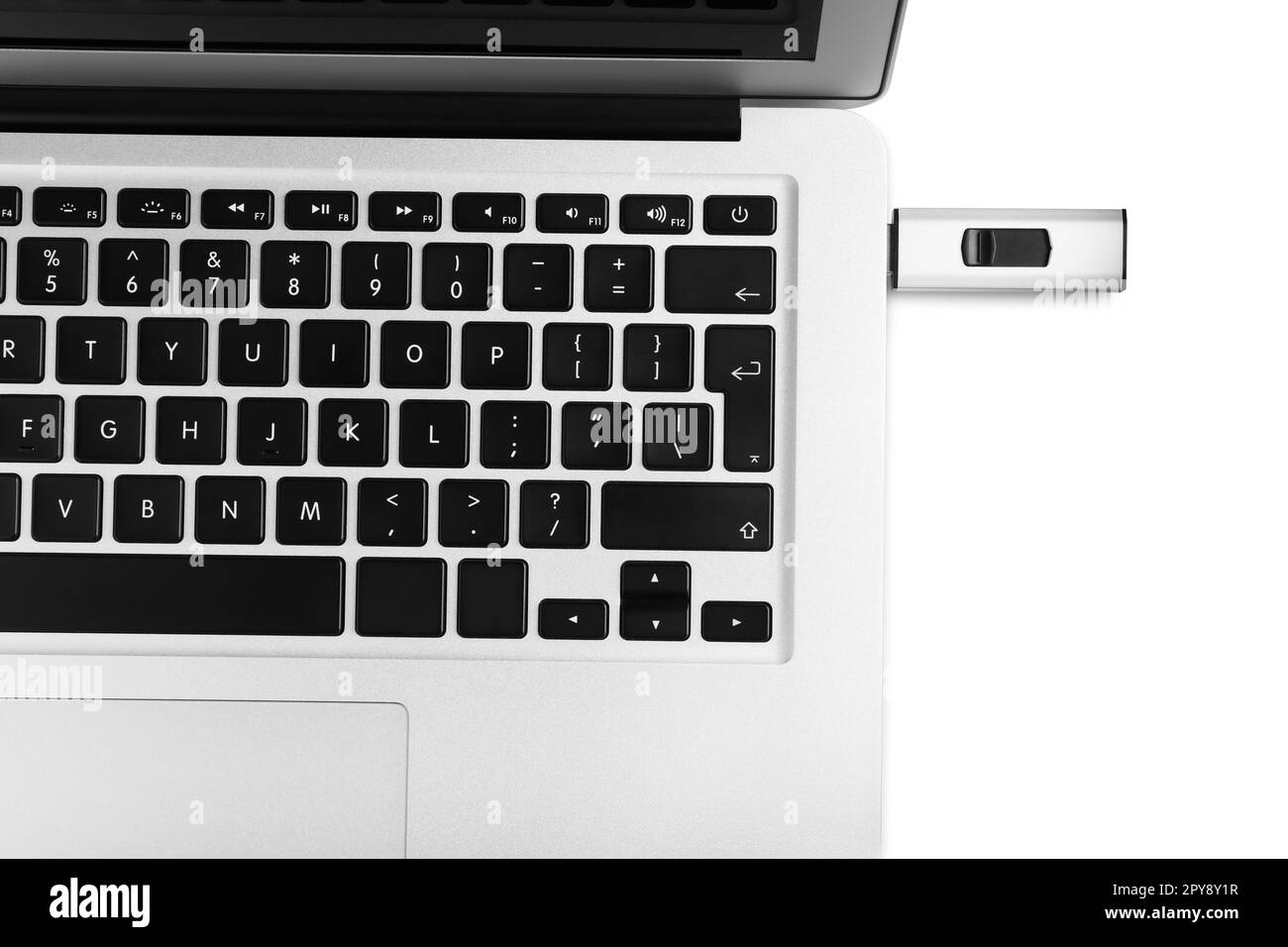 Modern usb flash drive attached into laptop on white background, top ...