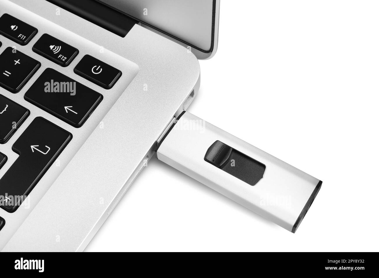 Modern usb flash drive attached into laptop on white background, top ...