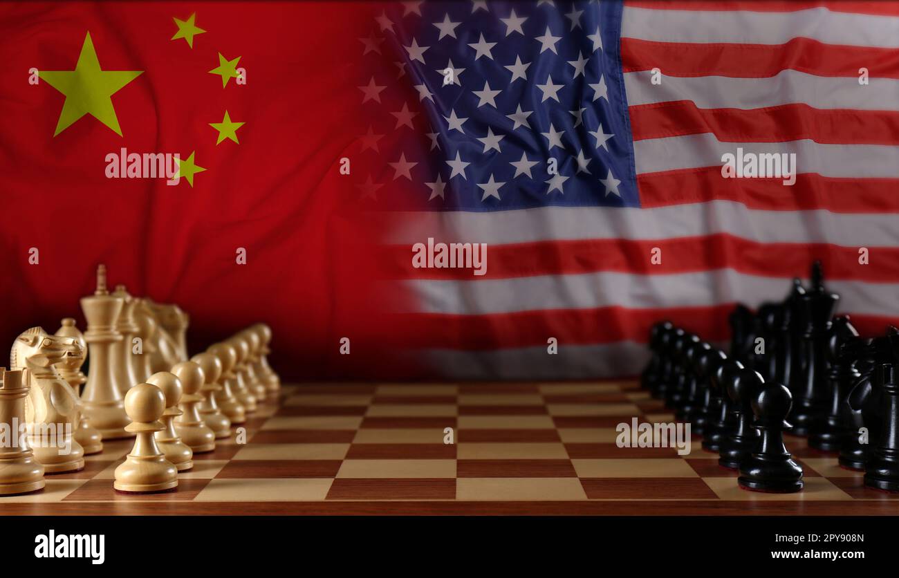 Chess pieces on board and Chinese and American flags on background ...