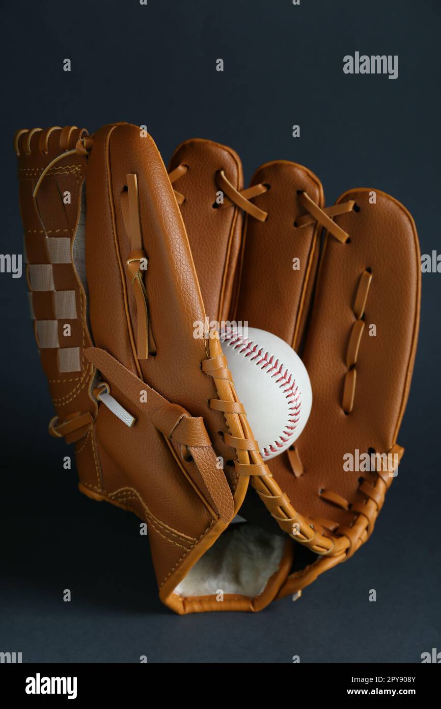 Catcher's mitt and baseball ball on dark background. Sports game Stock ...