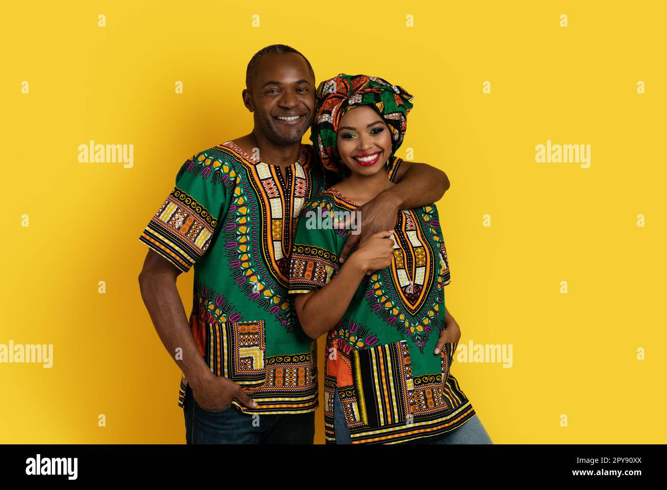 Beautiful african couple posing together on yellow background Stock ...