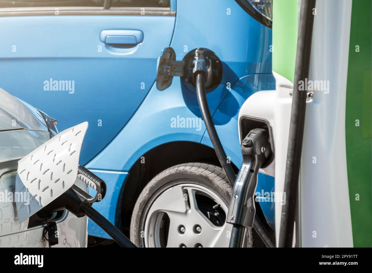 Electric car connected to EV charging station with EV charging cable ...