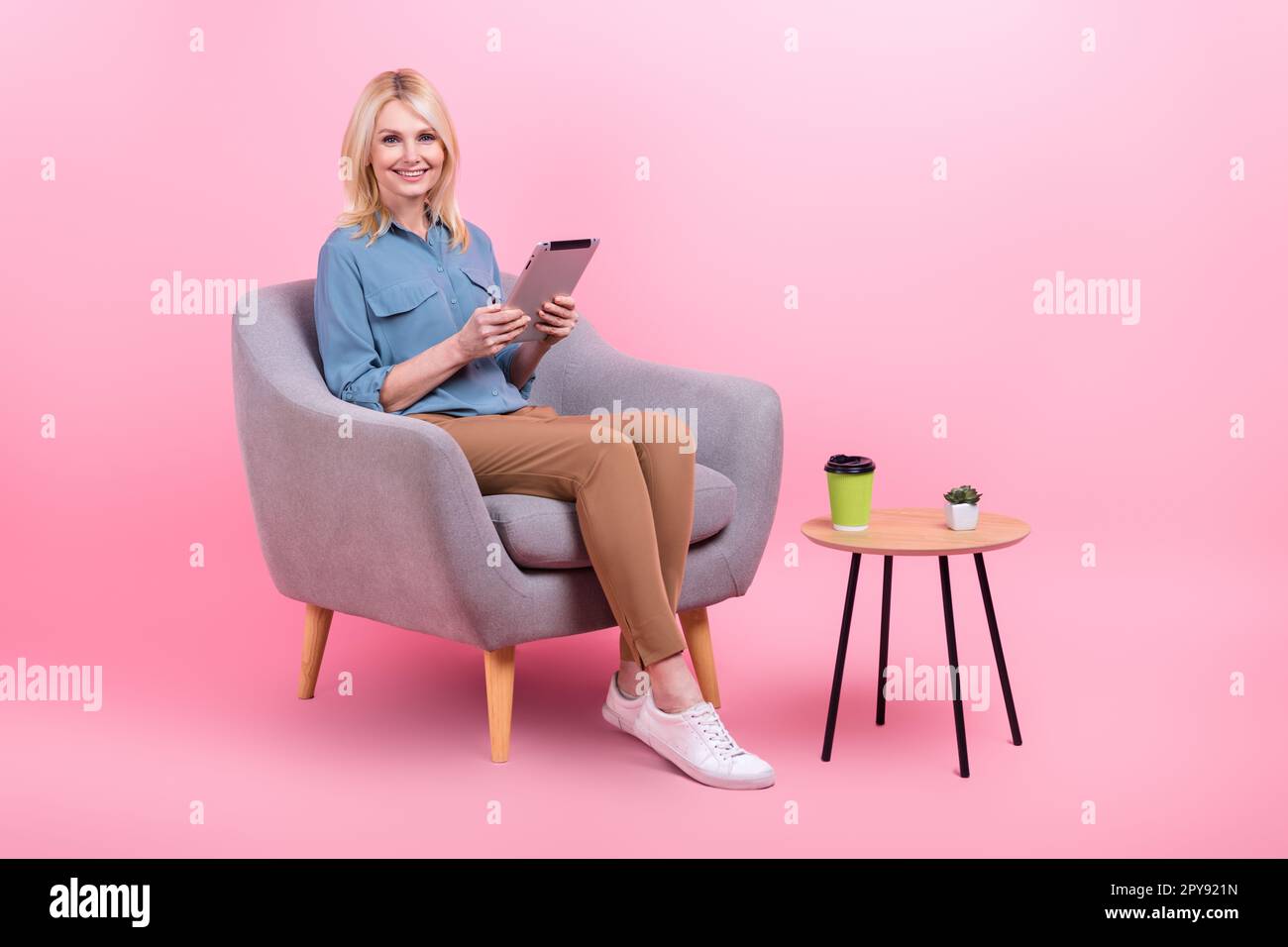 Photo of adorable retired lady successful worker use tablet sit ...