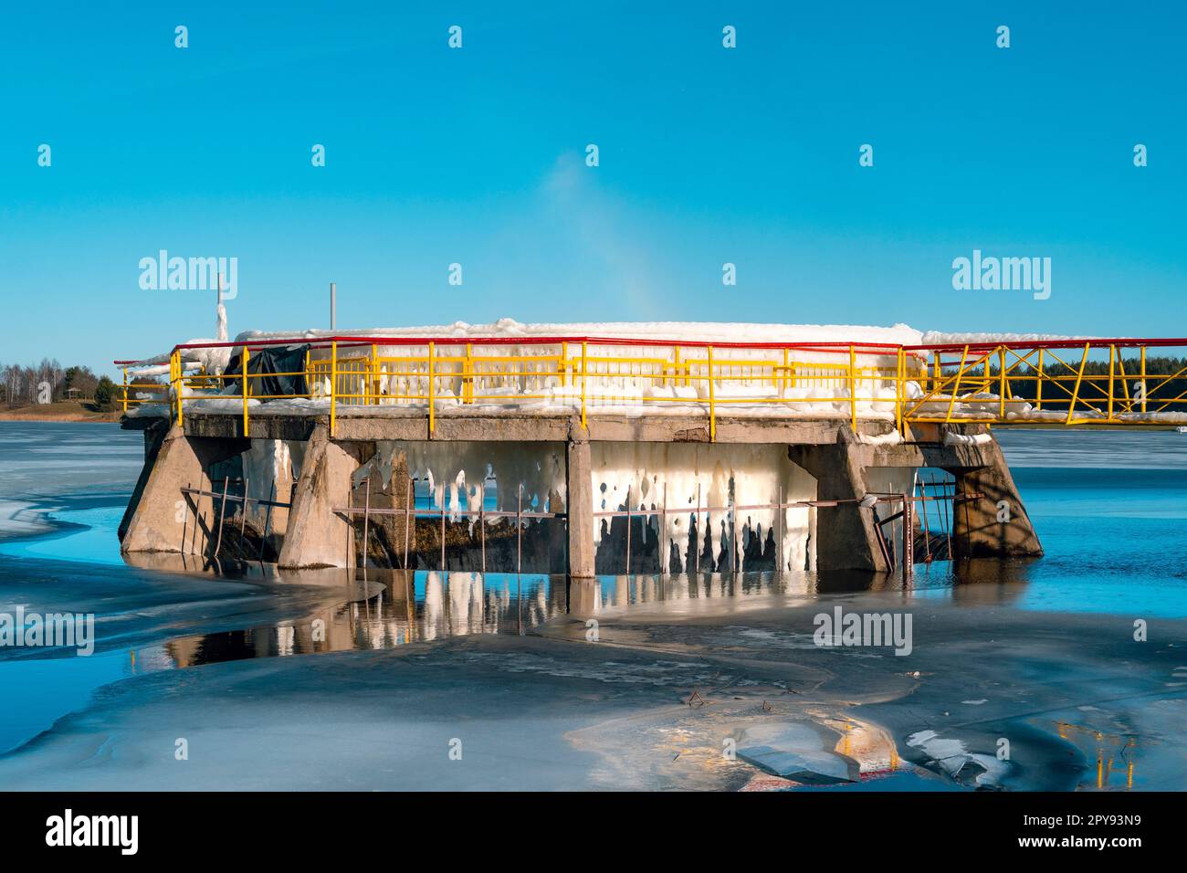 Ice covered metal construction of spillway on a small dam Stock Photo ...