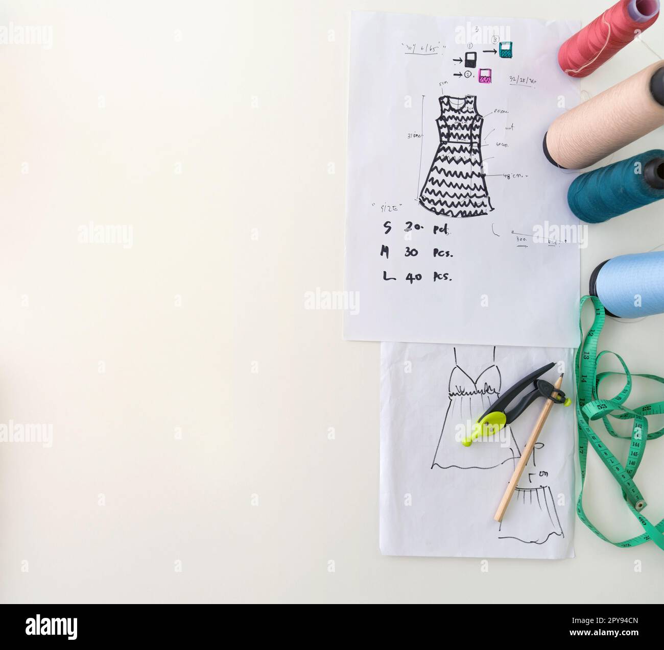 Fashion designer room. Pattern for cloth, multicolored thread spool ...