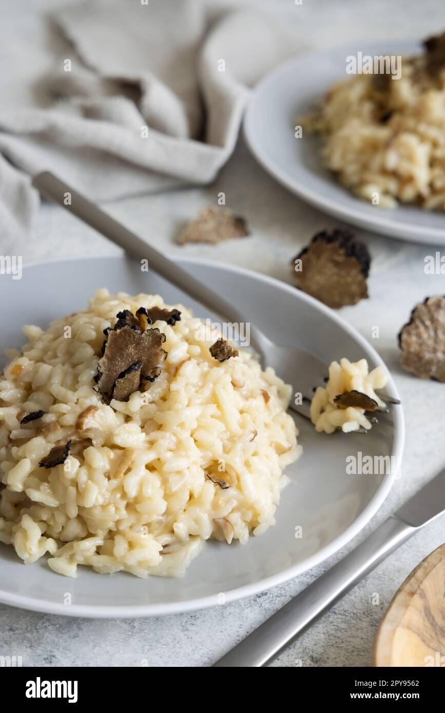 Risotto with porcini mushrooms and black truffles served in a plate top ...