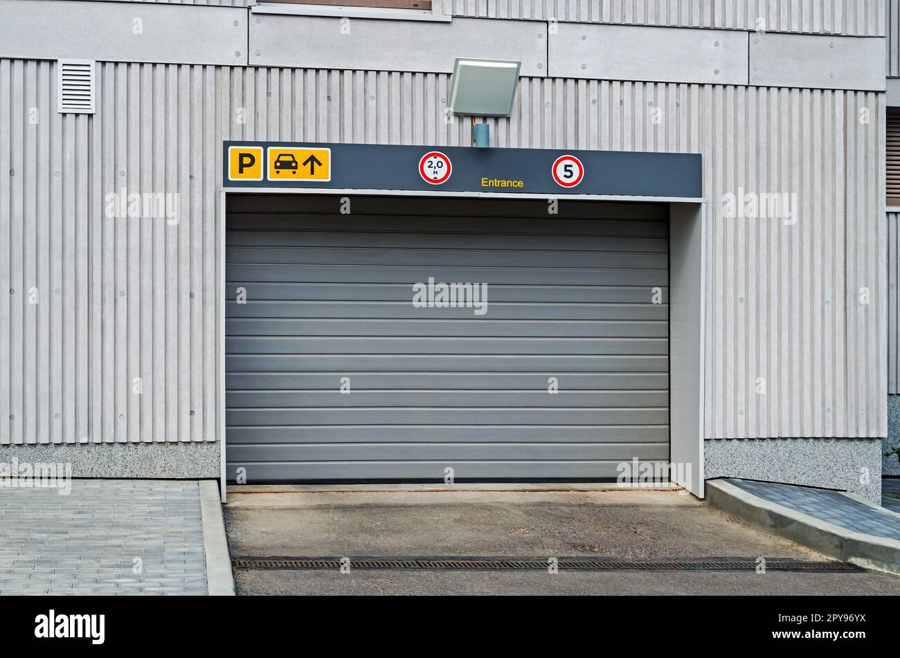 Automatic electric roll-up gate. Entrance in underground parking of ...