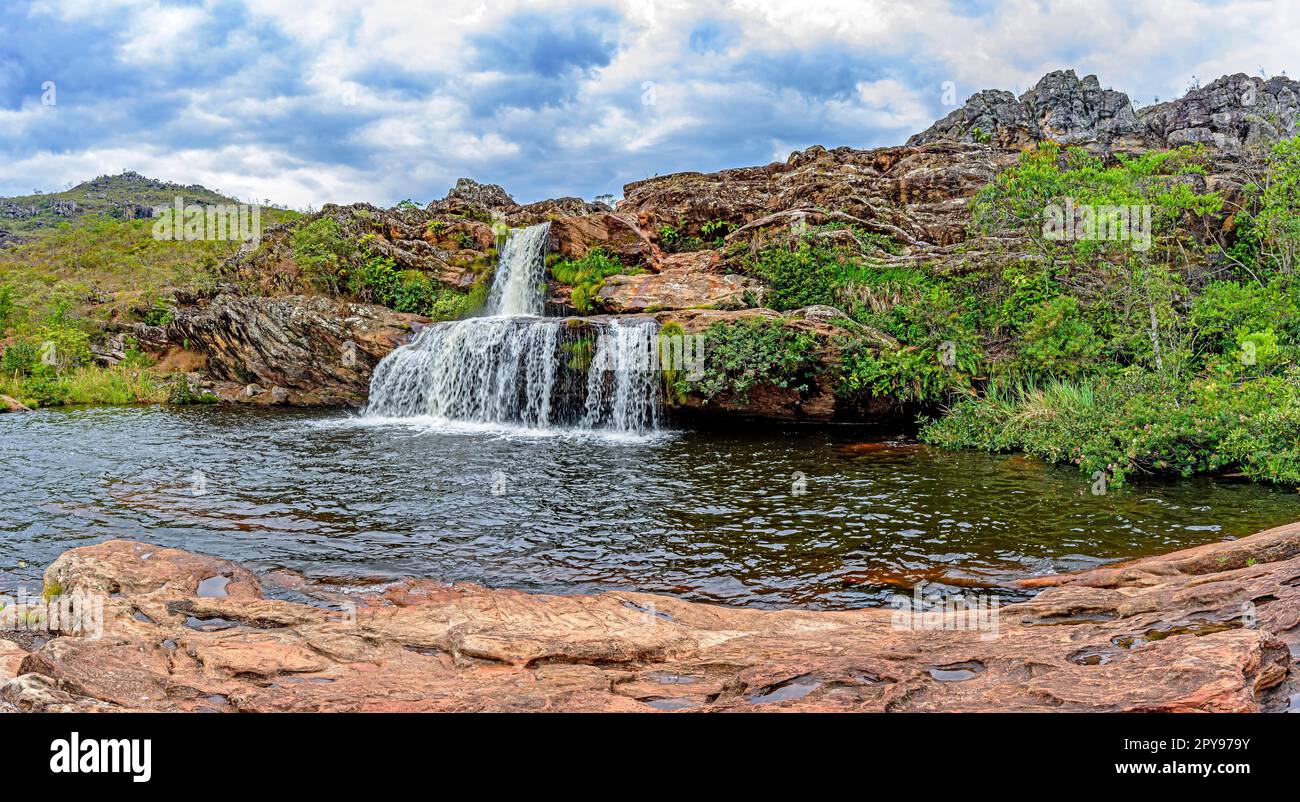 Cascade and lake with mountains in background on Biribiri environmental ...
