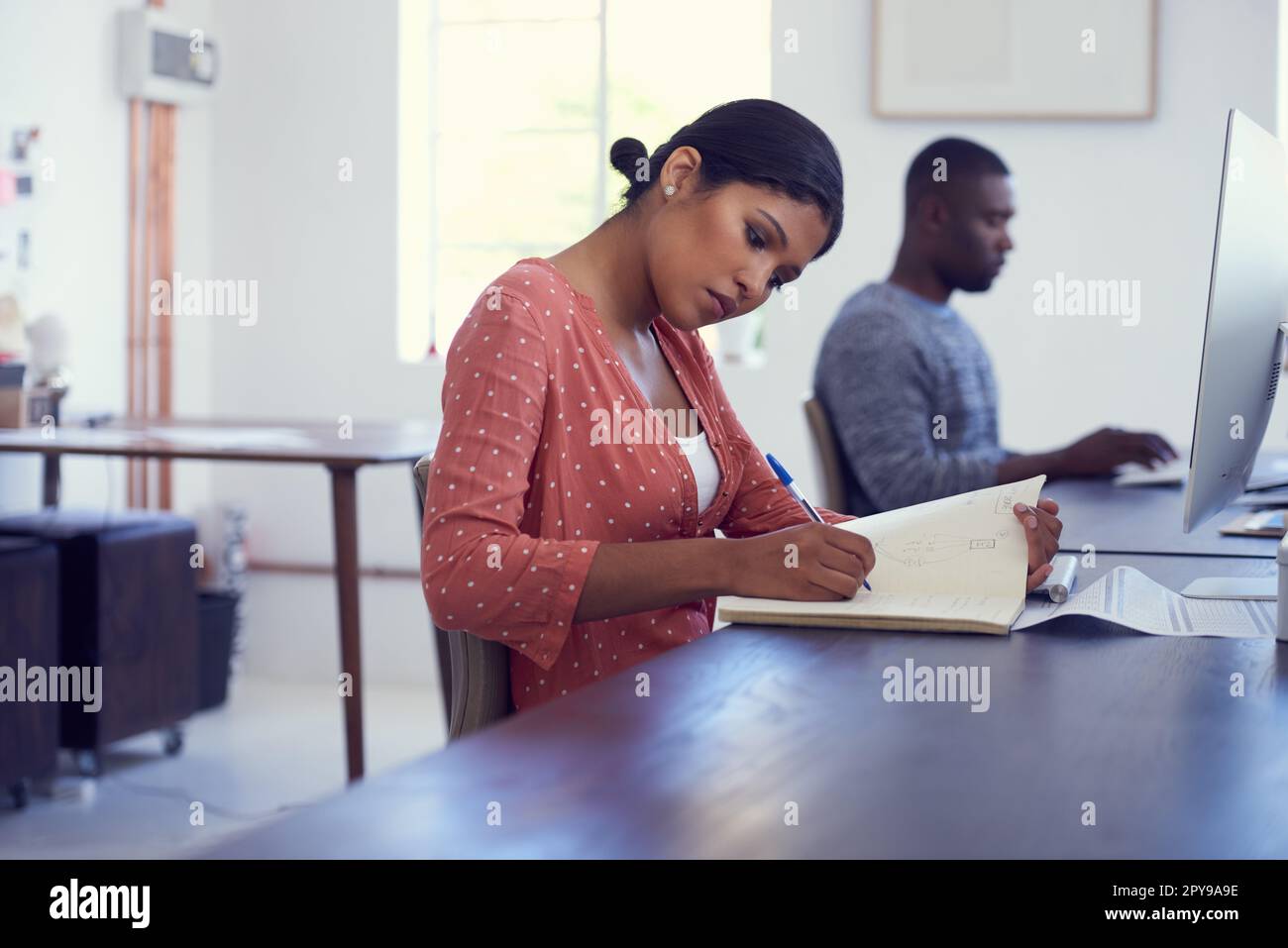 Tackling her work tasks with focus and dedication. a young ...
