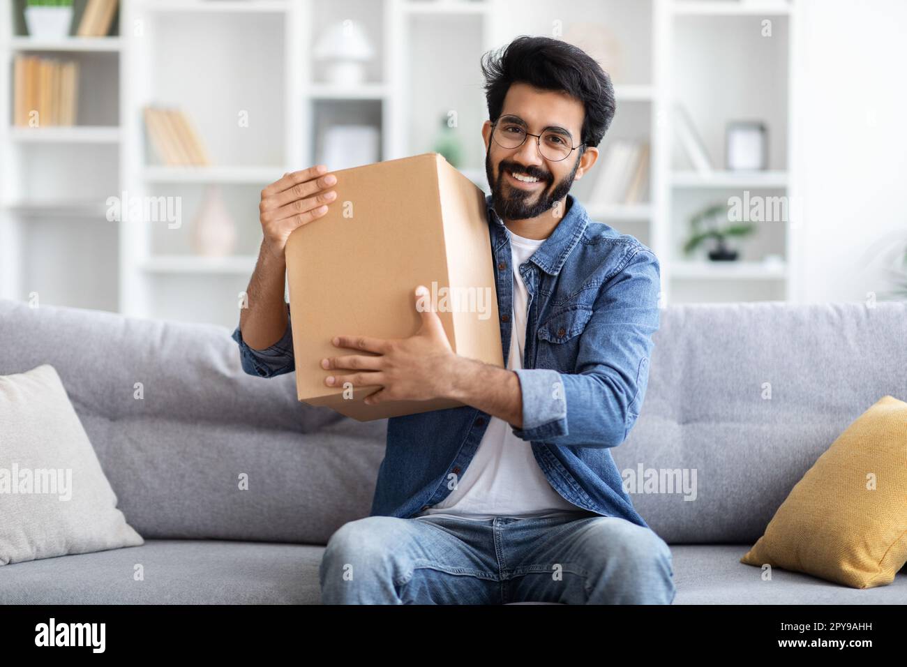 Happy Excited Indian Guy Embracing Cardboard Box With Delivery At Home ...