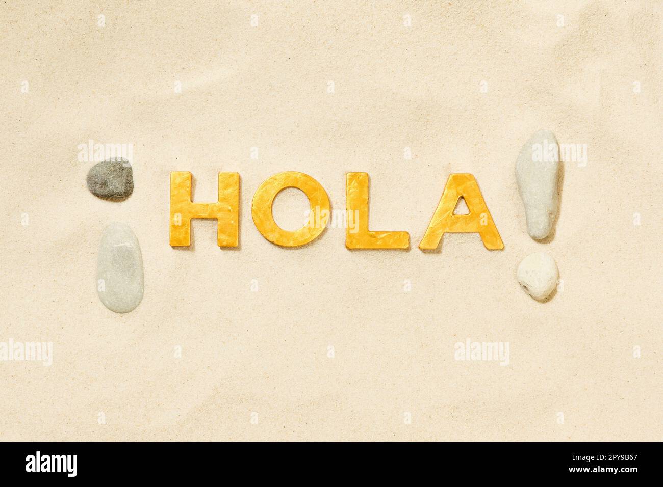 Hola! - Spanish greeting by golden letters in the white sand Stock ...