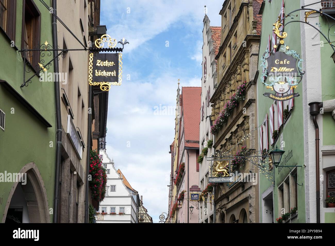 Various hanging signs in Rothenburg Stock Photo - Alamy