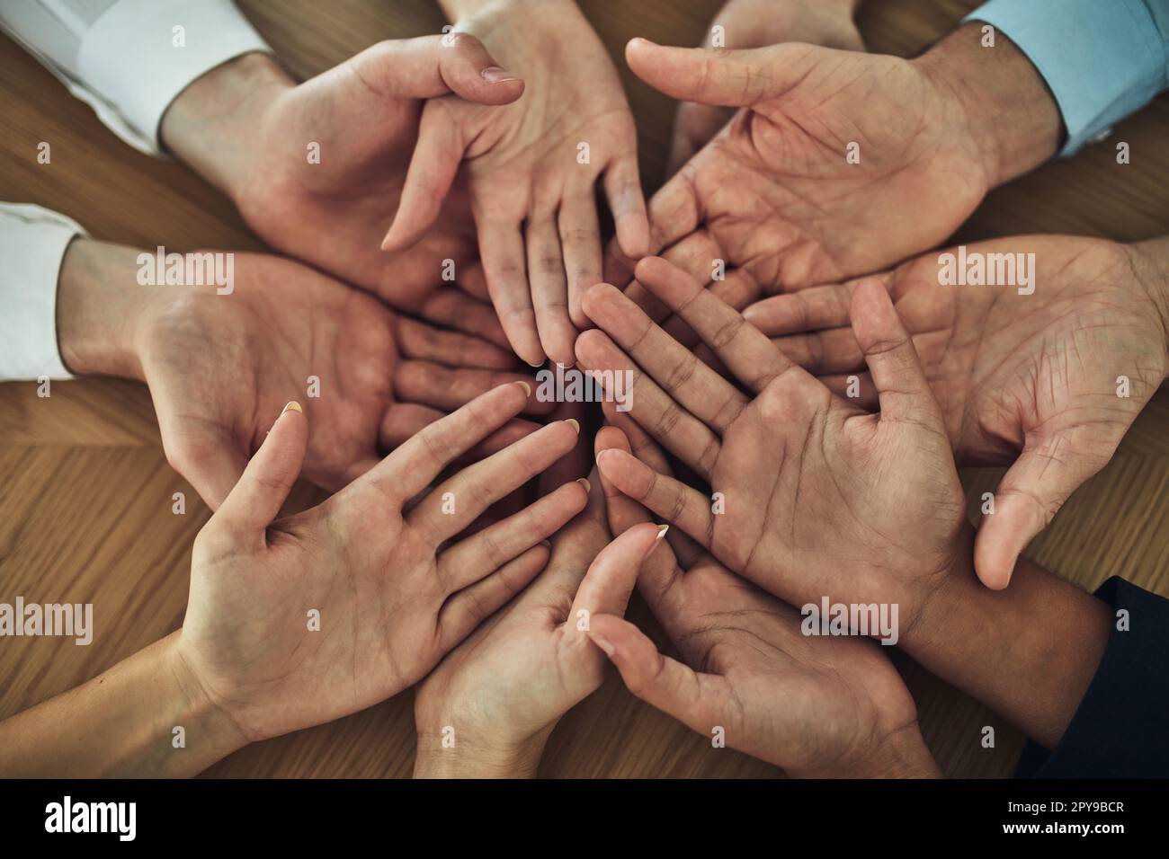 Open and willing to receive. a group of businesspeople with their hands ...