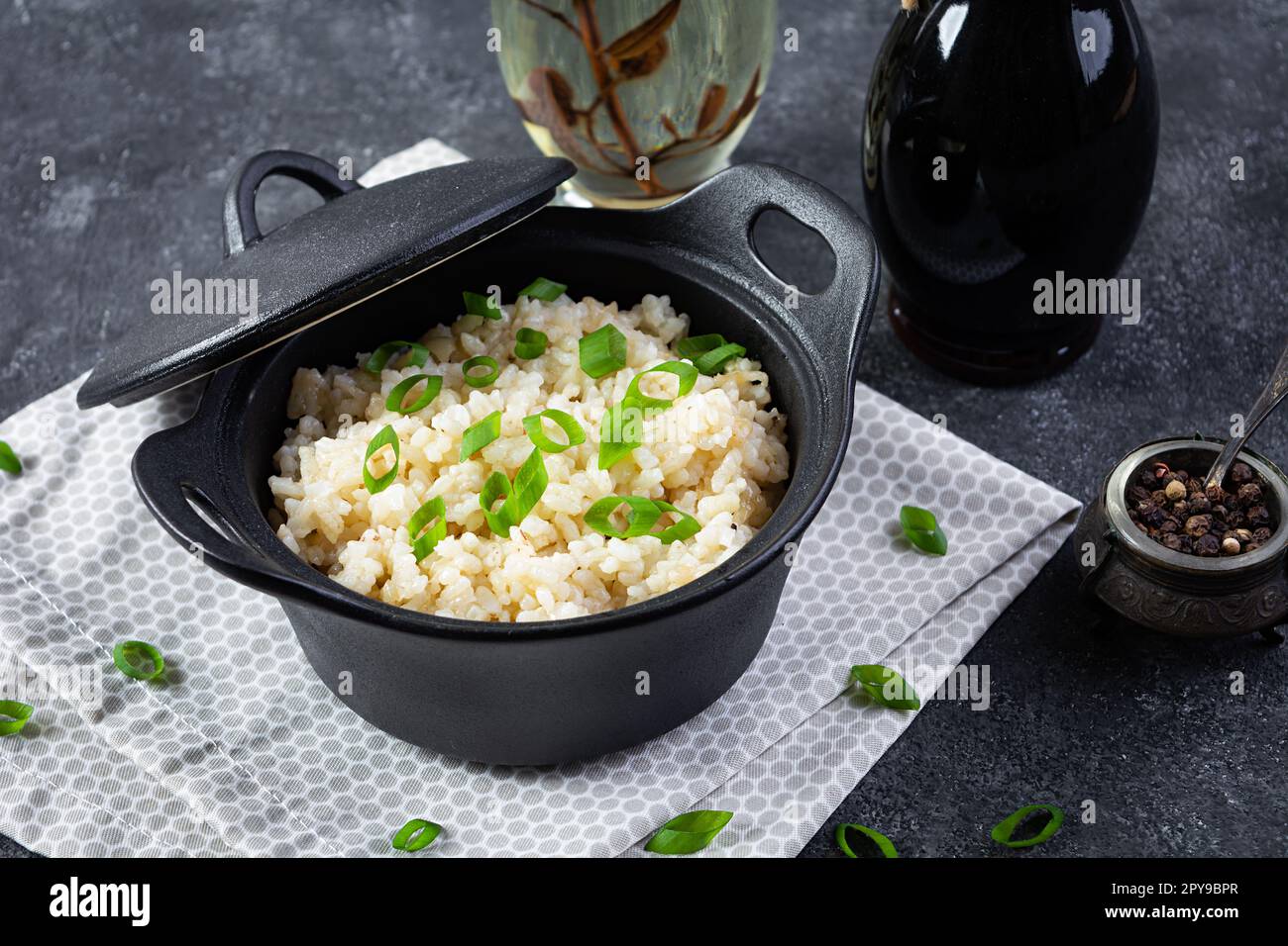 Stewed rice with chicken in a pot on dark grey background Stock Photo ...