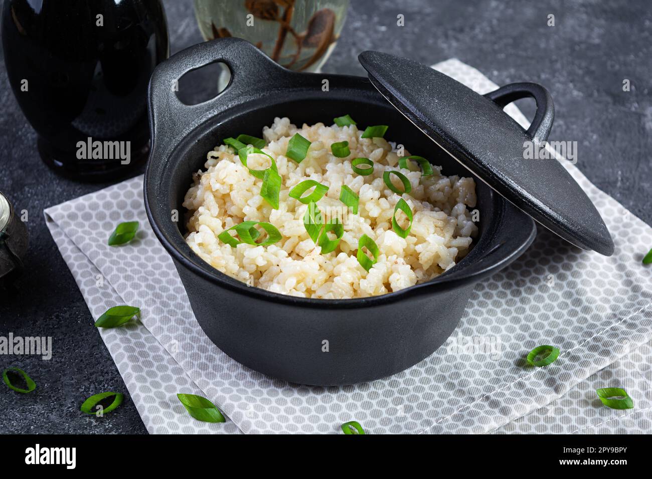 Stewed rice with chicken in a pot on dark grey background Stock Photo ...