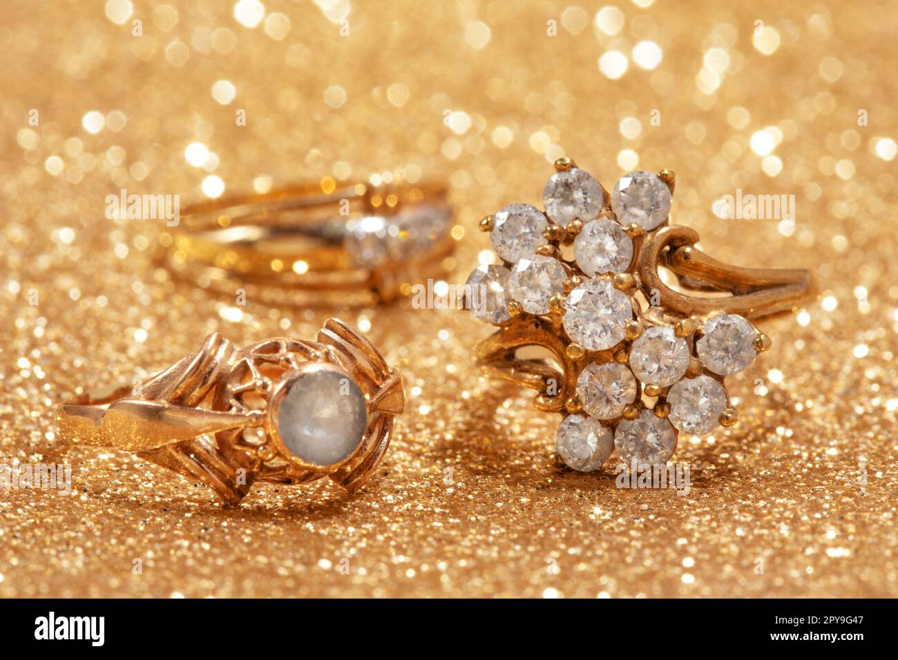 Gold rings on gold background Stock Photo - Alamy