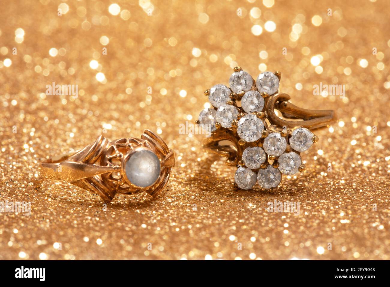 Gold rings on gold background Stock Photo - Alamy