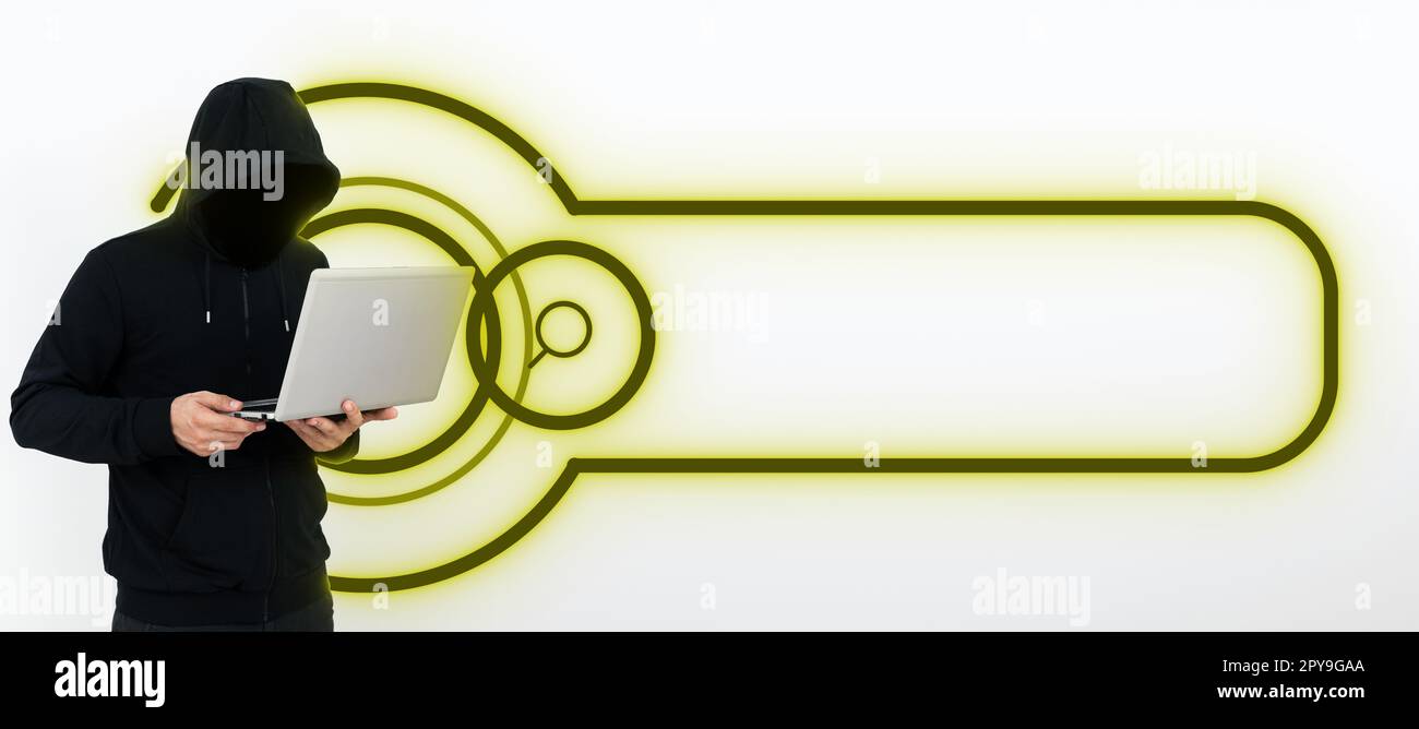 Male programmer in black hoodie stands and holds laptop. Hacker with ...