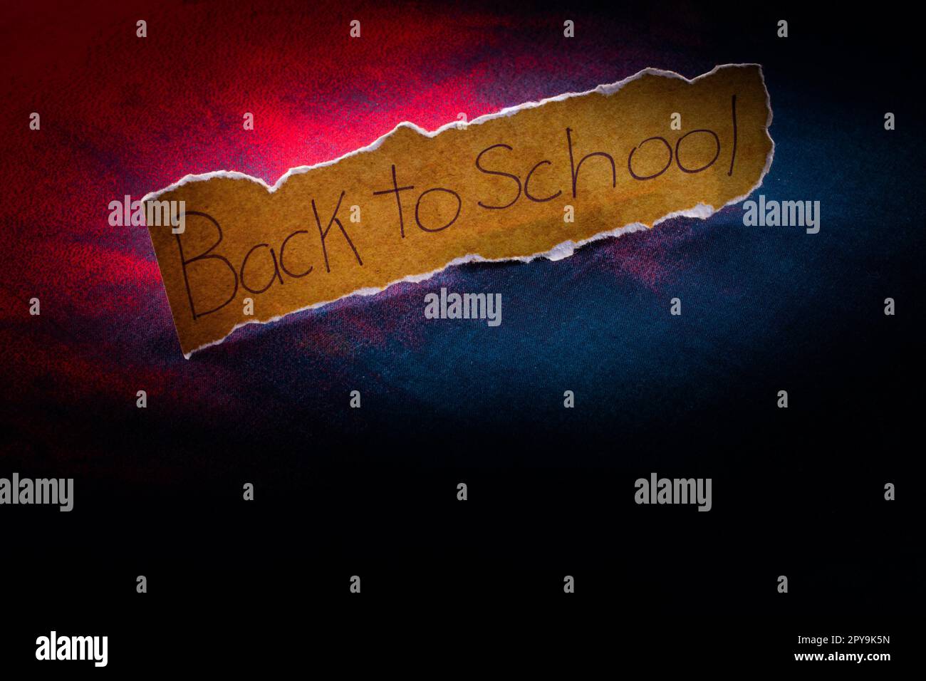 Back to school wording on a piece of torn paper Stock Photo - Alamy