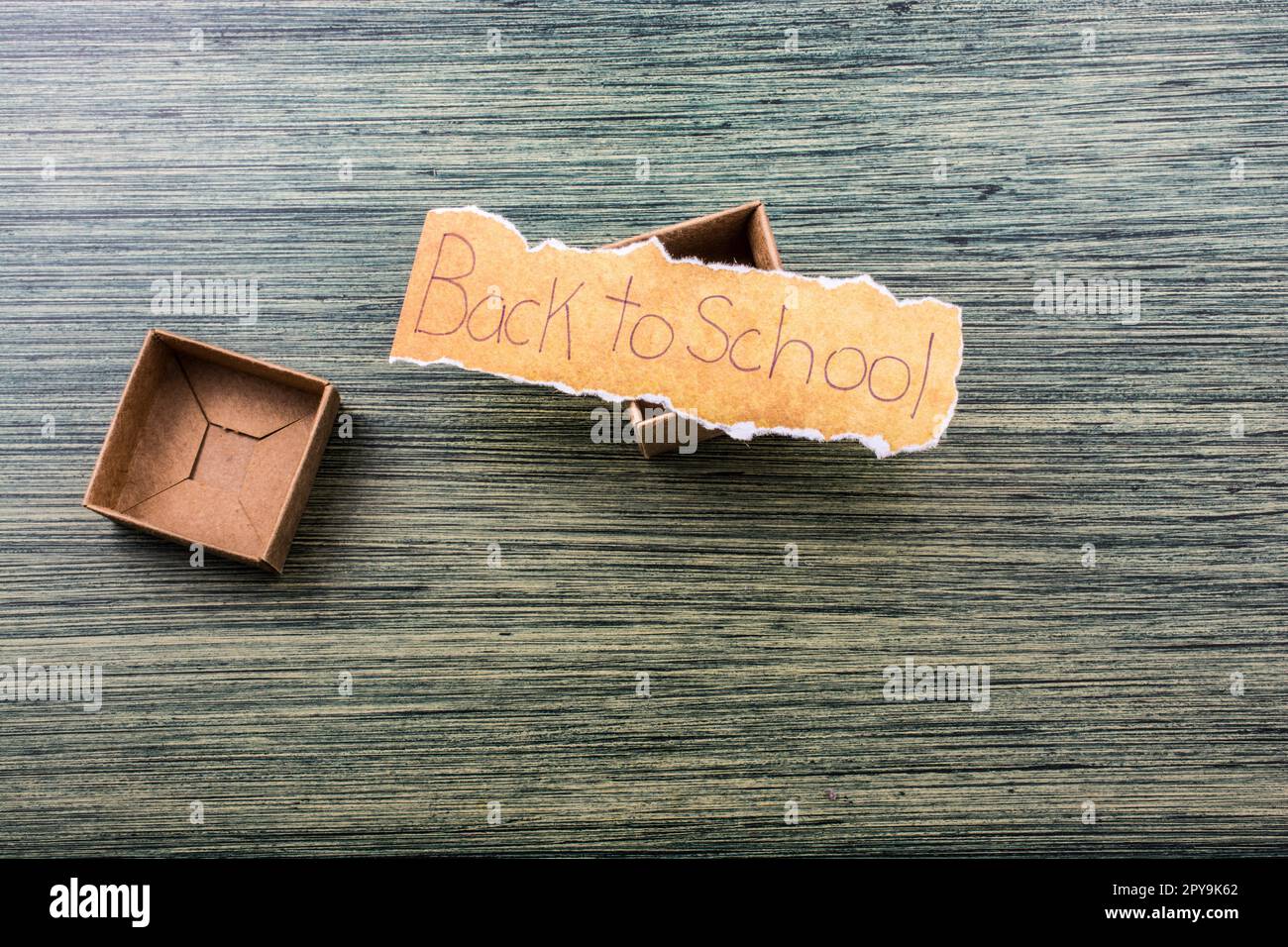 Back to school wording on a piece of torn paper Stock Photo - Alamy
