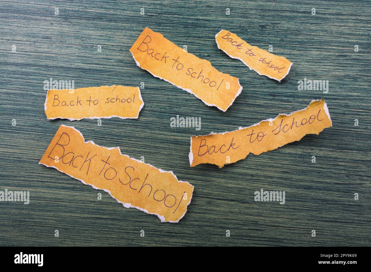 Back to school wording on a piece of torn paper Stock Photo - Alamy