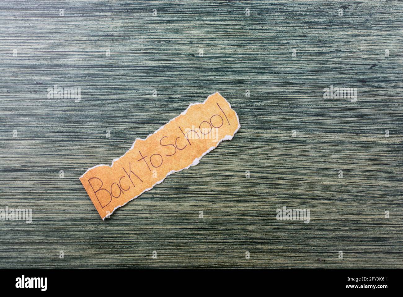 Back to school wording on a piece of torn paper Stock Photo - Alamy