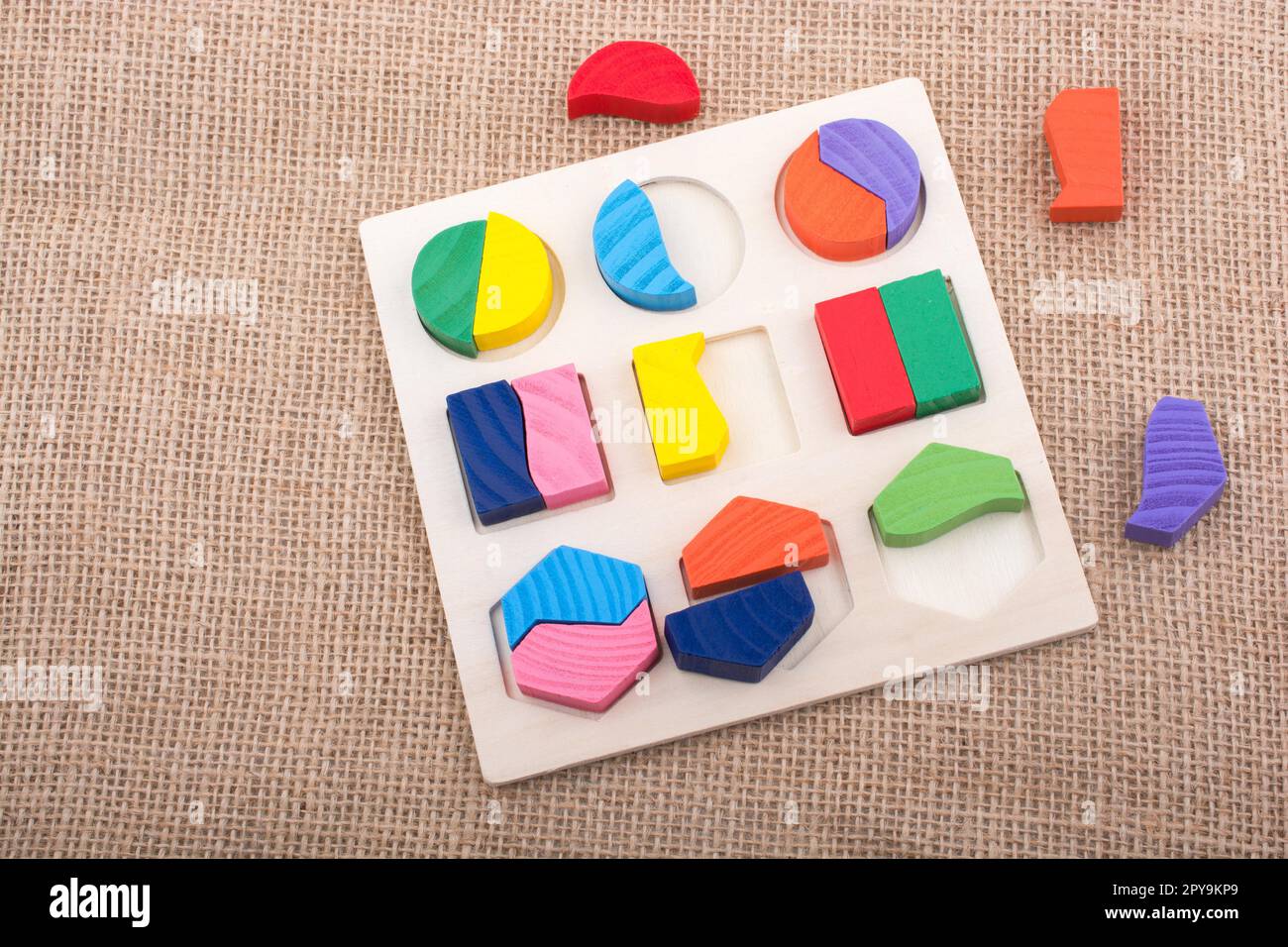 Colorful wooden pieces of a logic puzzle Stock Photo - Alamy