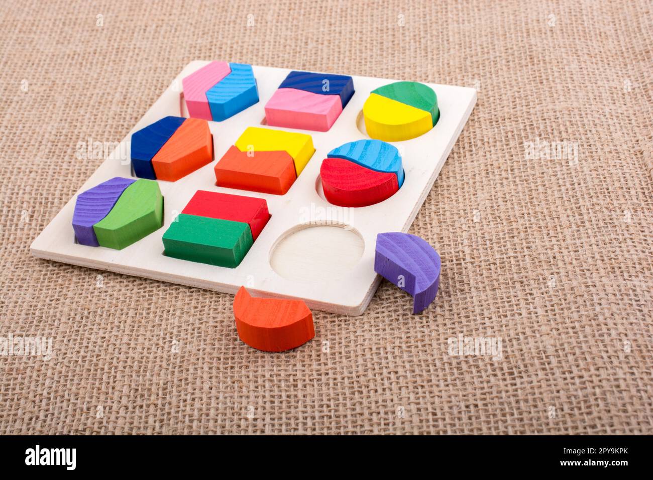 Colorful wooden pieces of a logic puzzle Stock Photo - Alamy