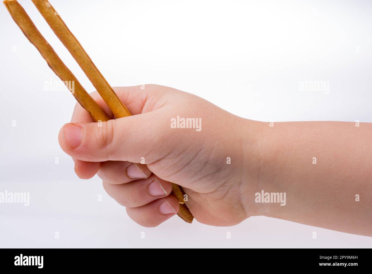Child Hand holding crackers in his hand Stock Photo - Alamy
