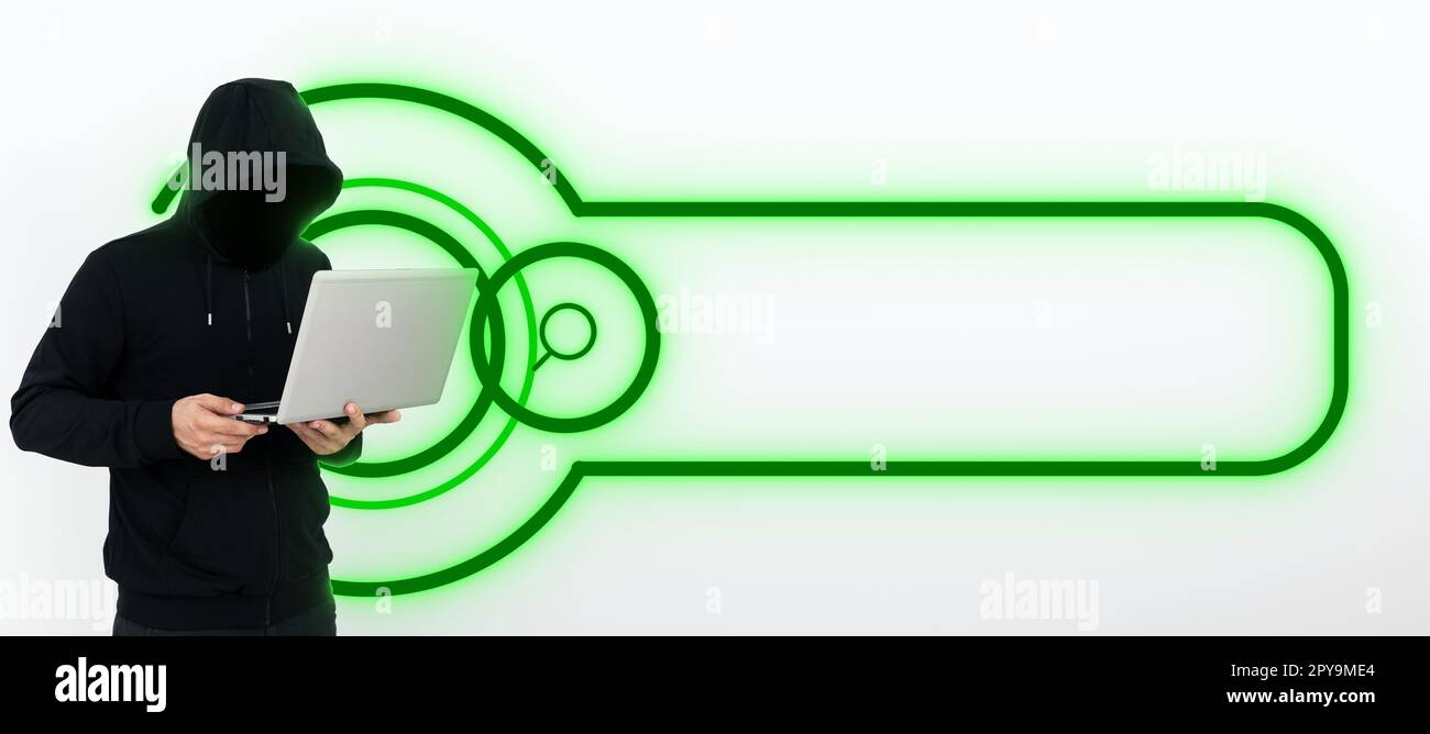 Male programmer in black hoodie stands and holds laptop. Hacker with ...