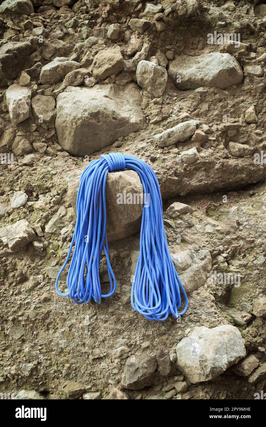 Blue climbing rope leaning against a rock face in Mallos de Riglos ...