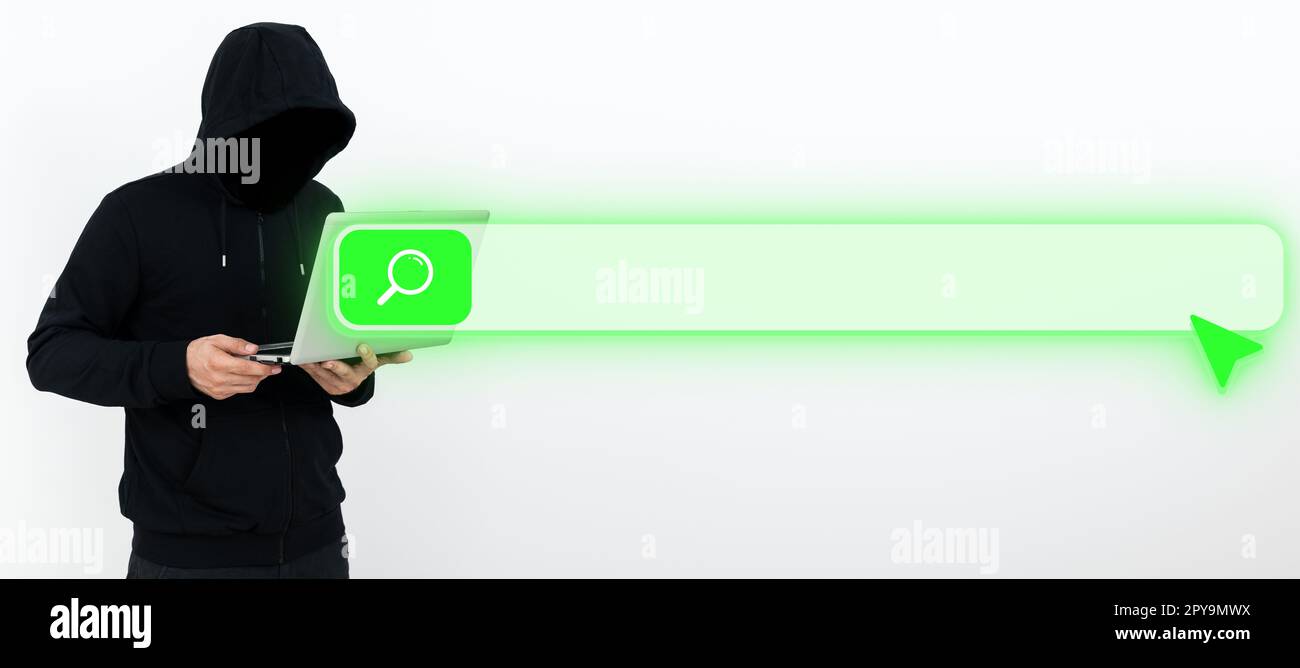 Male programmer in black hoodie stands and holds laptop. Hacker with ...