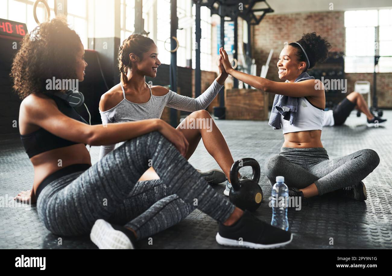 Workout buddies keep you motivated. young women giving each other a ...