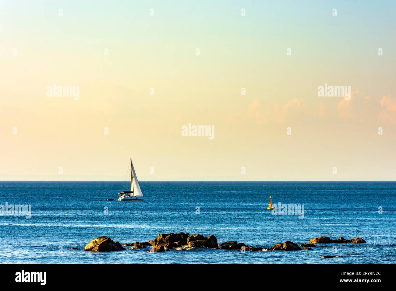 Sailing boat sailing over the calm waters of Baia de Todos os Santos in ...