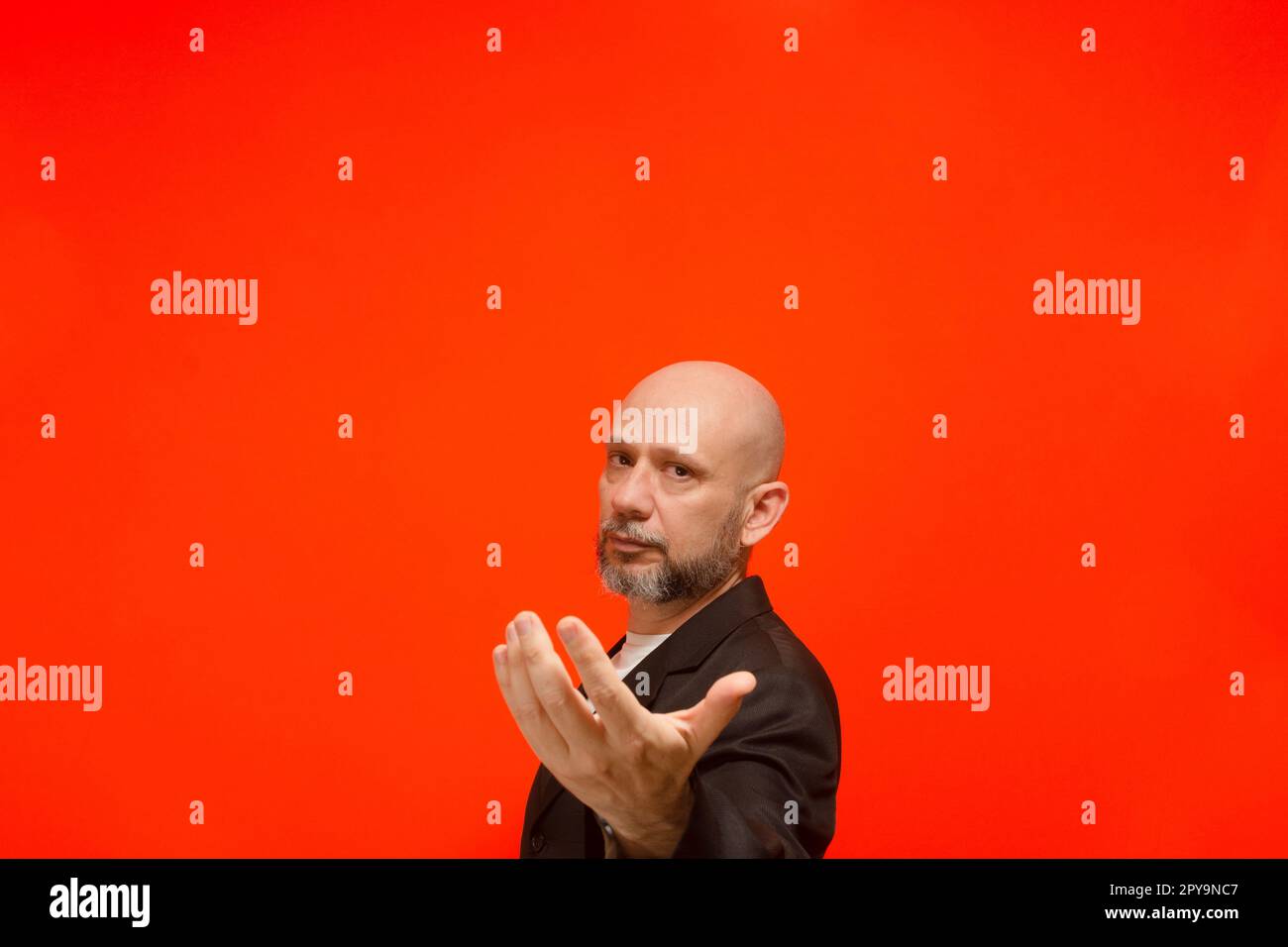 Portrait of a stylish business man making hand gestures. Looking at the ...