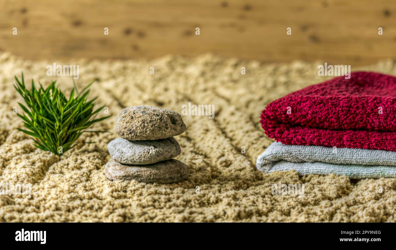 Decorating towels with 3 stones stacked on top of each other Stock ...