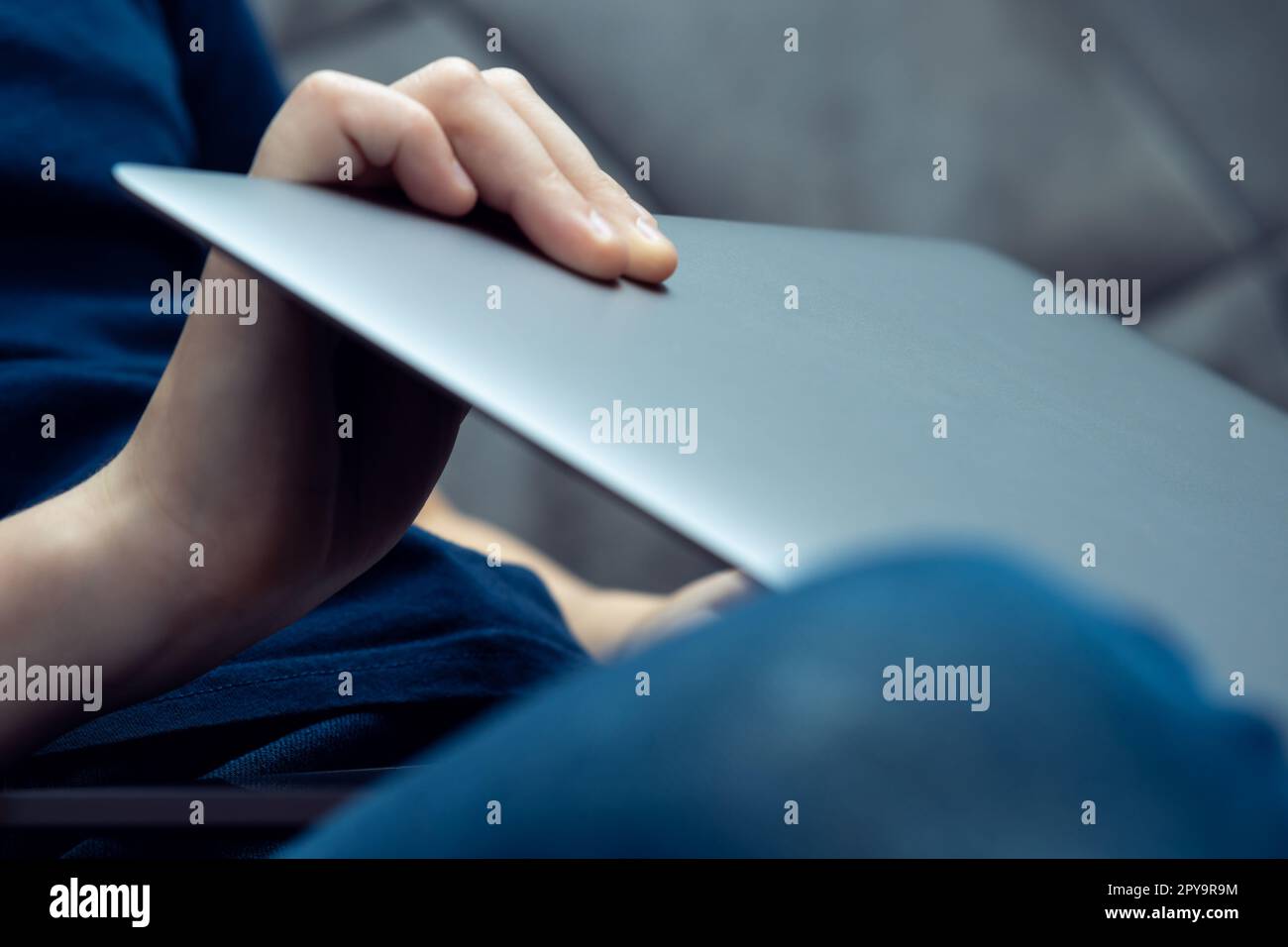 Digital laptop computer in male hands, side view closeup. Young ...