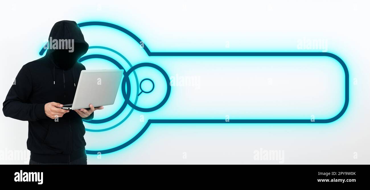 Male programmer in black hoodie stands and holds laptop. Hacker with ...